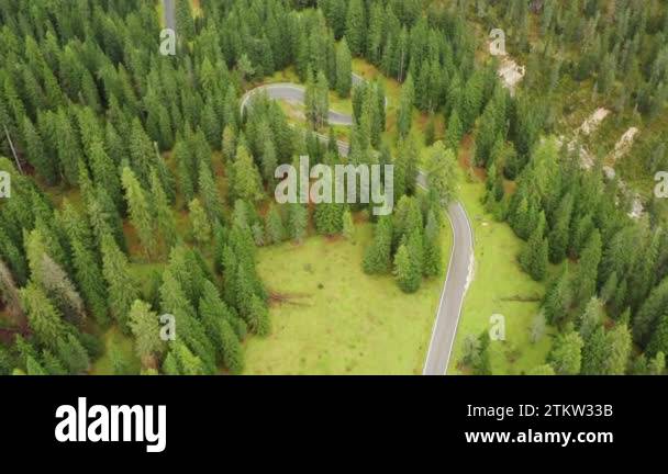 Black car driving on famous Snake Road serpentine surrounded by forests ...