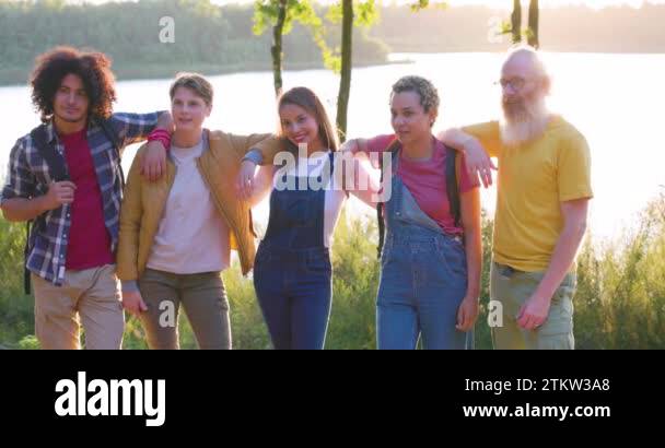 Symbols of friendship. Group of ethnically diverse people standing arm ...