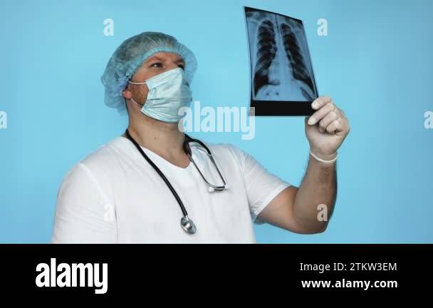 In the hospital, a pulmonologist doctor with an x-ray of a person's ...