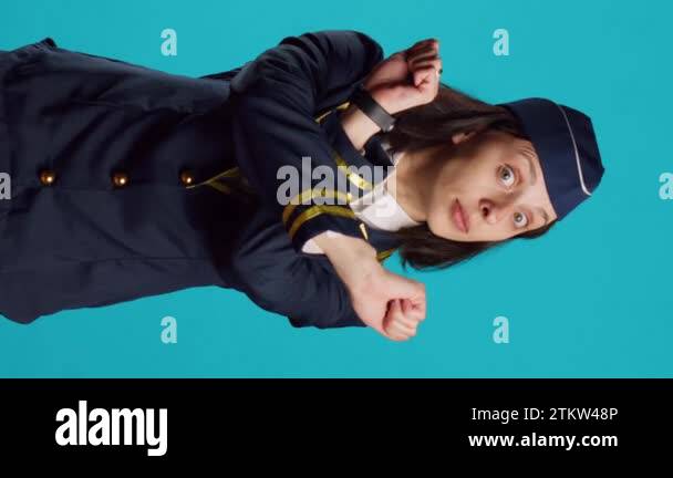Vertical video: Young air hostess doing x shape gesture and showing ...