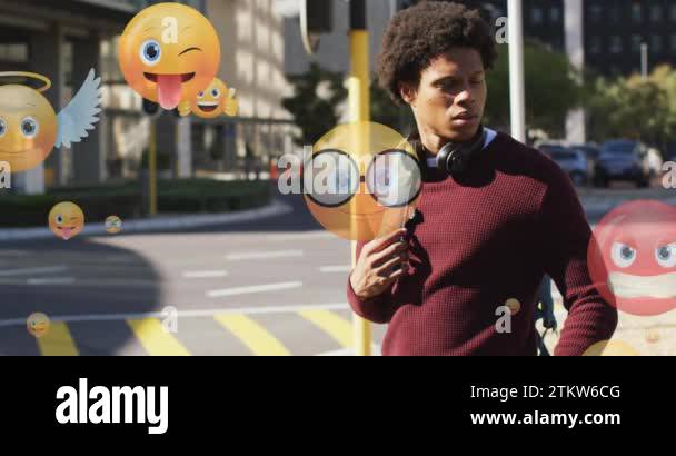 Animation of multiple emojis over biracial man walking and scrolling on ...