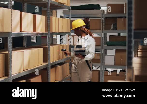 Young woman scanning barcodes on packages to work on stock logistics ...