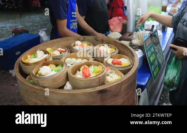 Malaysian man at Dim Sum stall on the night market in Malaysia ...