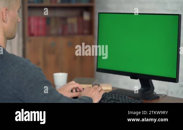 Man Typing on Keyboard and Looking at Green Screen Computer.Chrome key ...