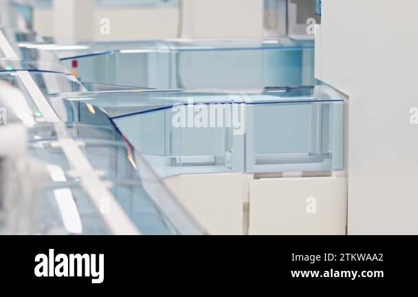 Vials moving one by one in an automated lab glass line. Lab concept ...