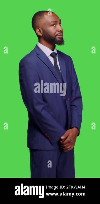 Vertical video: Side view of confident businessman standing over ...