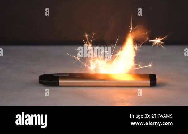 The electronic cigarette burns with a bright flame and sparks fly on a ...