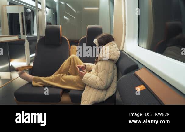 Teenage girl traveling on high-speed express train underground ...