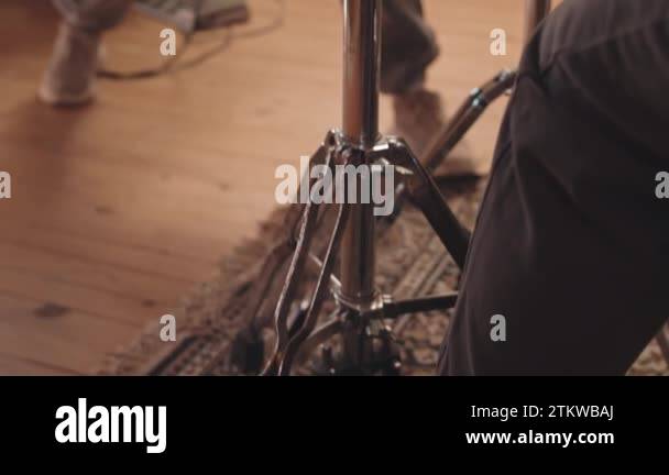 Tilt up slowmo of passionate rock guitarist shaking his head while ...