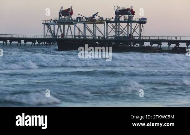beach waves with oil platform in ocean. Caspian sea offshore oil rig ...