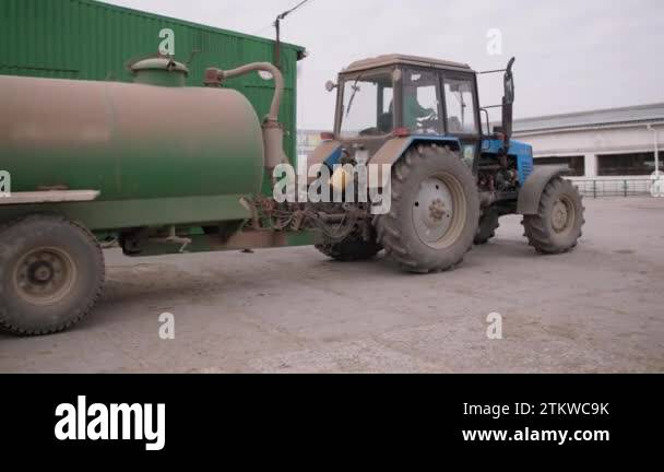 dairy farm, tractor with cylindrical trailer for transporting milk on ...