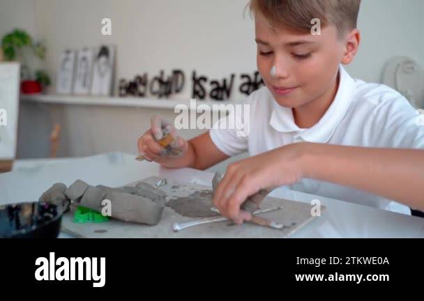 Teen Boy At Art School Clay Sculpt in Art Class. Middle school kid ...