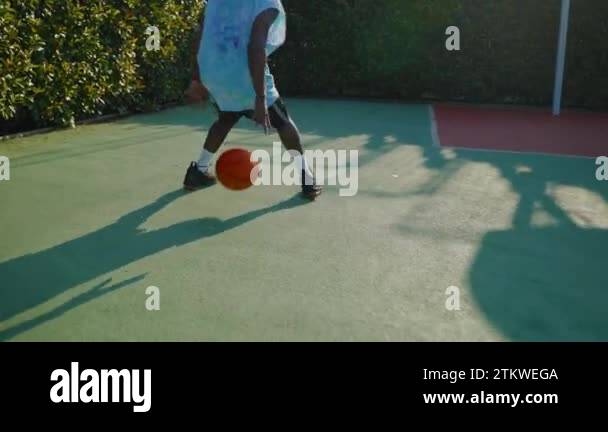 skilled basketball player is dribbling ball and throwing to basket, two ...