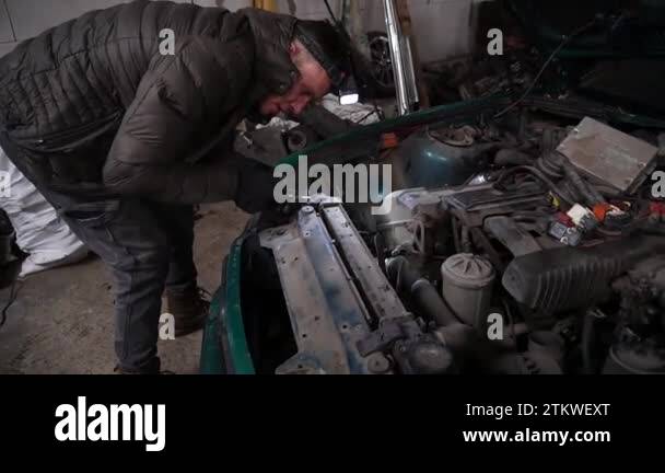 a mechanic disassembles a car to install a turbo engine tuning drift ...