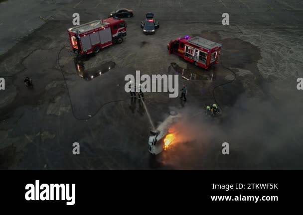 Aerial drone footage of a group of professional firefighters working ...