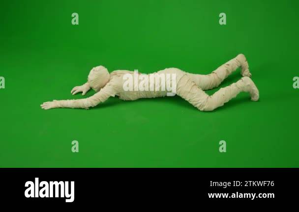 Green screen isolated chroma key video capturing a mummy crawling on ...
