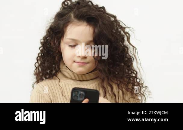 Little cute girl shows smart phone blank horizontal green screen chroma ...