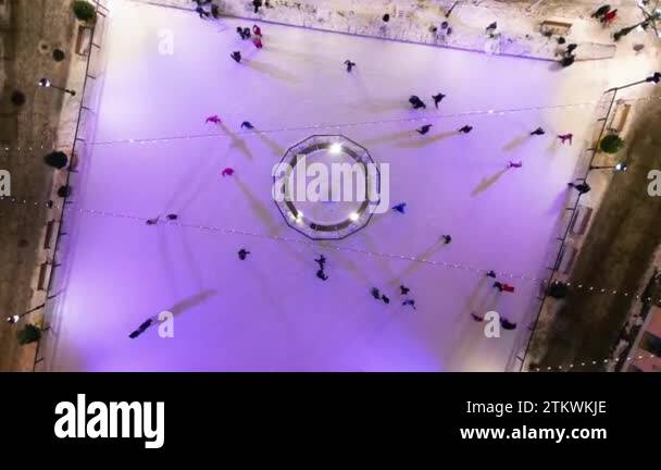 Old town market square in Tartu, Estonia. People skate on ice rink city ...