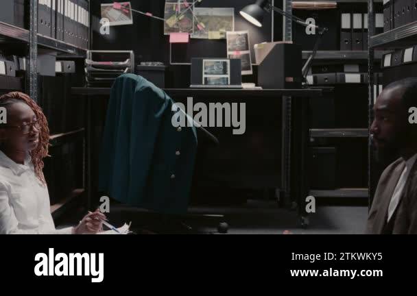 Team of detectives conducting criminal investigation in evidence room ...