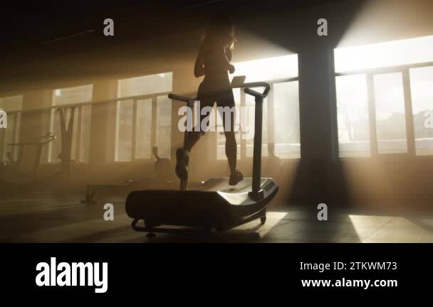 Unrecognized female athlete during her fitness and cardio routine. Back ...