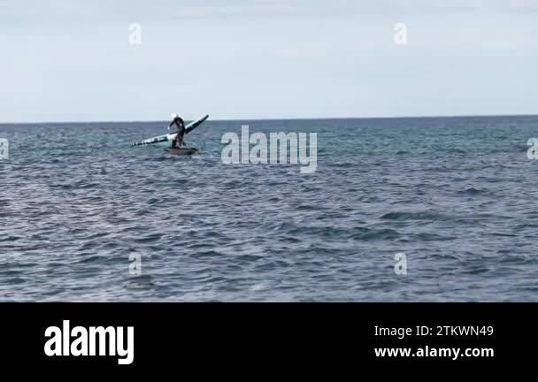 Modern water sport. Hydrofoil ride on the ocean using the wing and the ...