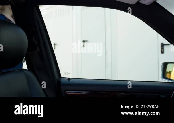 A beautiful female police officer knocks on a car window and points gun ...