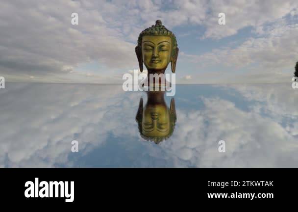 Buddha head sculpture on mirror and sky clouds, time lapse 4K Stock ...