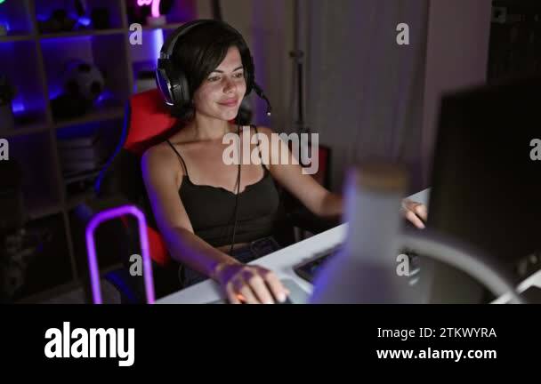 Victorious young hispanic woman, a beautiful gamer streamer ...