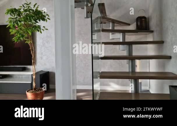 Modern staircase with wooden steps and glass railings, frosted glass ... Modern staircase with wooden steps and glass railings, frosted glass ...