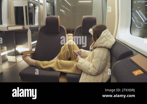 Teenage girl traveling on high-speed express train underground ...