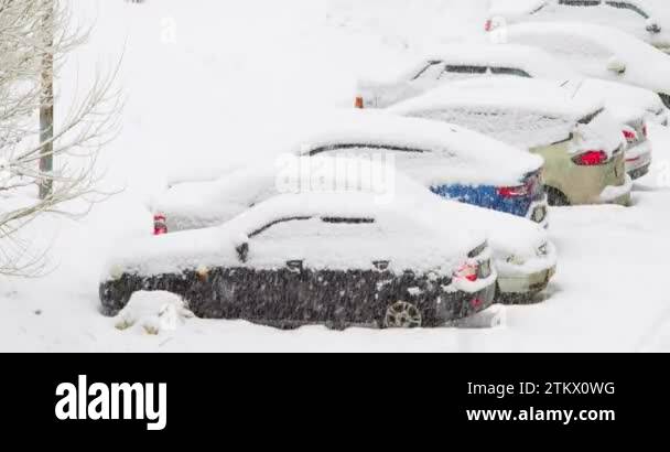 4k video of a snow covered cars during a snowstorm. Swaying air during ...