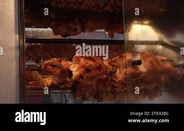 Rotating Delicious Rotisserie Chicken Turkey. Chicken cooking at stall ...
