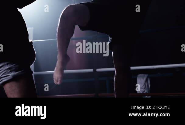 Fighter's leg striking opponent in slow-motion inside boxing ring at ...