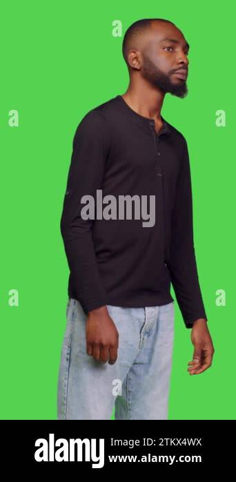 Vertical video: Side view of male model feeling pensive thinking about ...