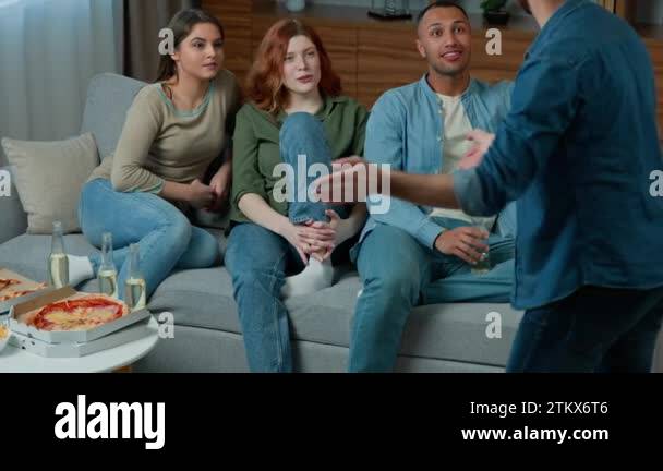 Group of happy diverse men women having fun play charades millennial ...