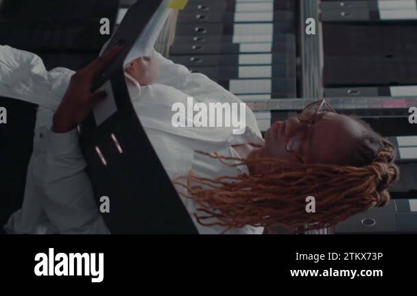 Vertical video: Private agents analyzing crime scene evidence on map ...