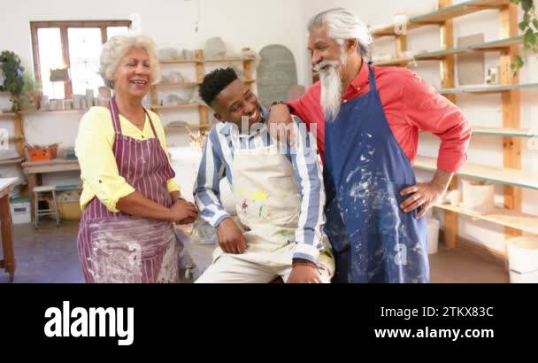 Happy diverse group of potters smiling in pottery studio. Pottery ...