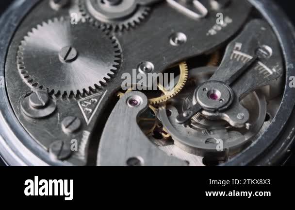 The mechanism of vintage stopwatch rotates close-up. Round clock watch ...