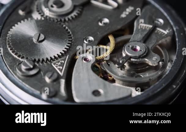 The mechanism of vintage stopwatch rotates close-up. Round clock watch ...