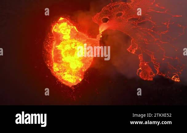 Volcano eruption at night, Red burning lava erupts from crater in ...