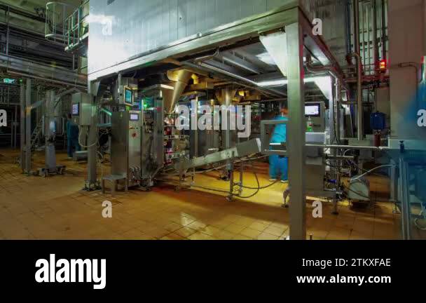Workers in sterile uniform control production processes at factory ...