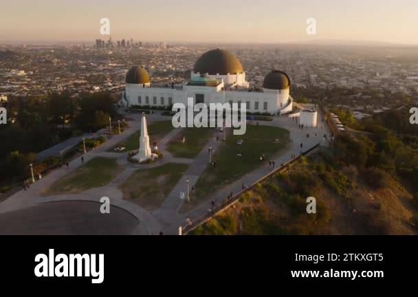 Dramatic sunset lens flare with downtown Los Angeles skyline on motion background. Aerial around ...