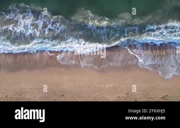 Cinematic top view of crystal clear sea and sand beach drone video ...