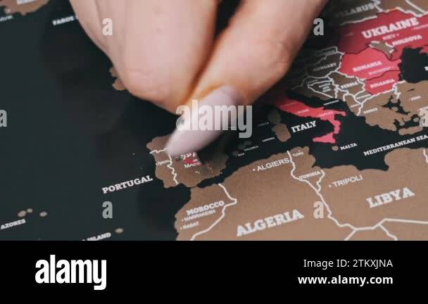 Scratching country of Spain on the Surface of Scratch World Map. Female ...