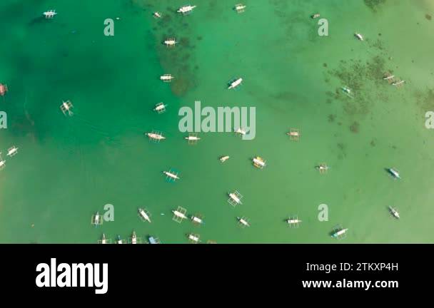 aerial view of cove with Lagoon with many tourist boats, city El nido ...