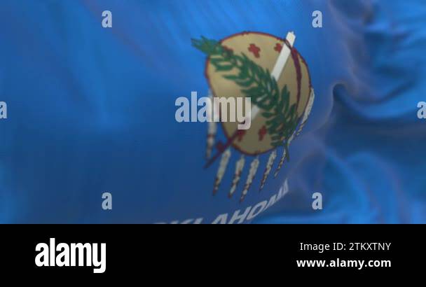 Detail of the Oklahoma state flag waving. Blue field with a buffalo ...