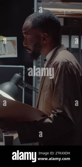 Vertical video: Detectives colleagues examining criminal files in ...