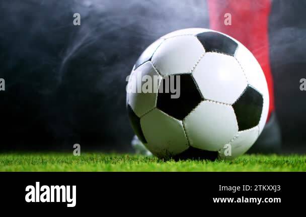 Close-up of Football Player Kicking Soccer Ball, Fog in Background ...