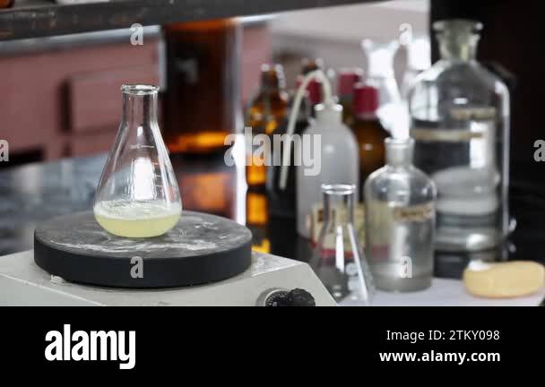 Boiling the soap and chemicals in an Erlenmeyer flask on hot plates ...