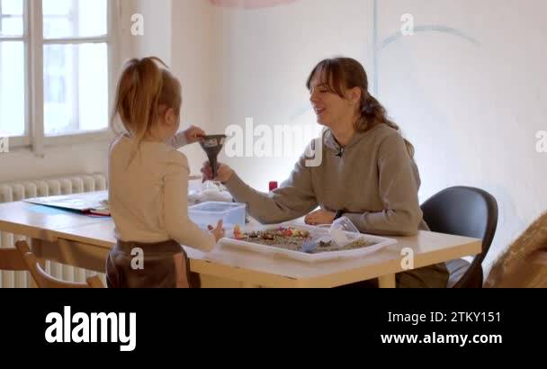 Woman and girl at therapy session. Private lesson psychologist with ...